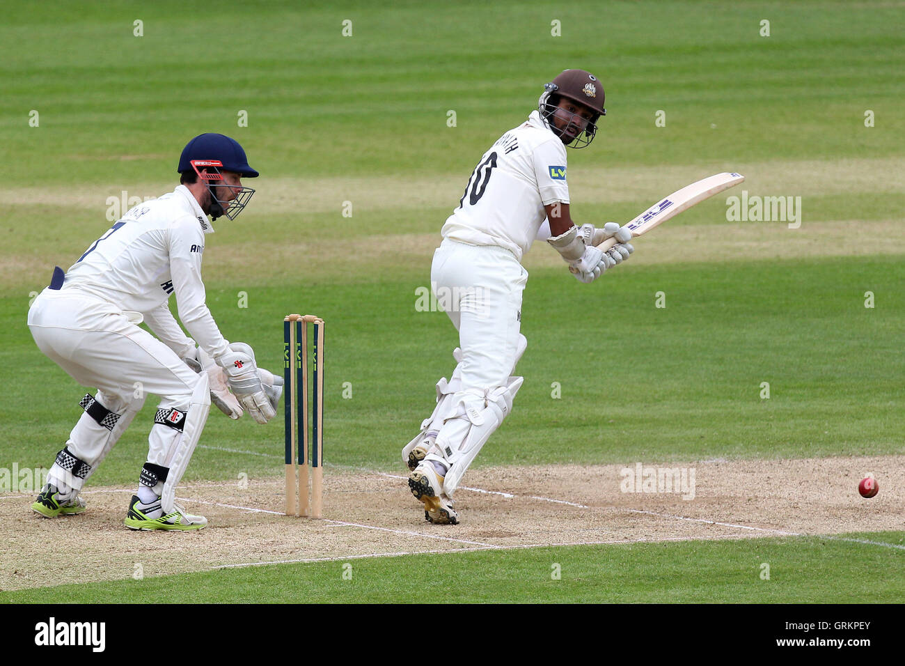 Arun Harinath in batting action for Surrey as James Foster looks on ...