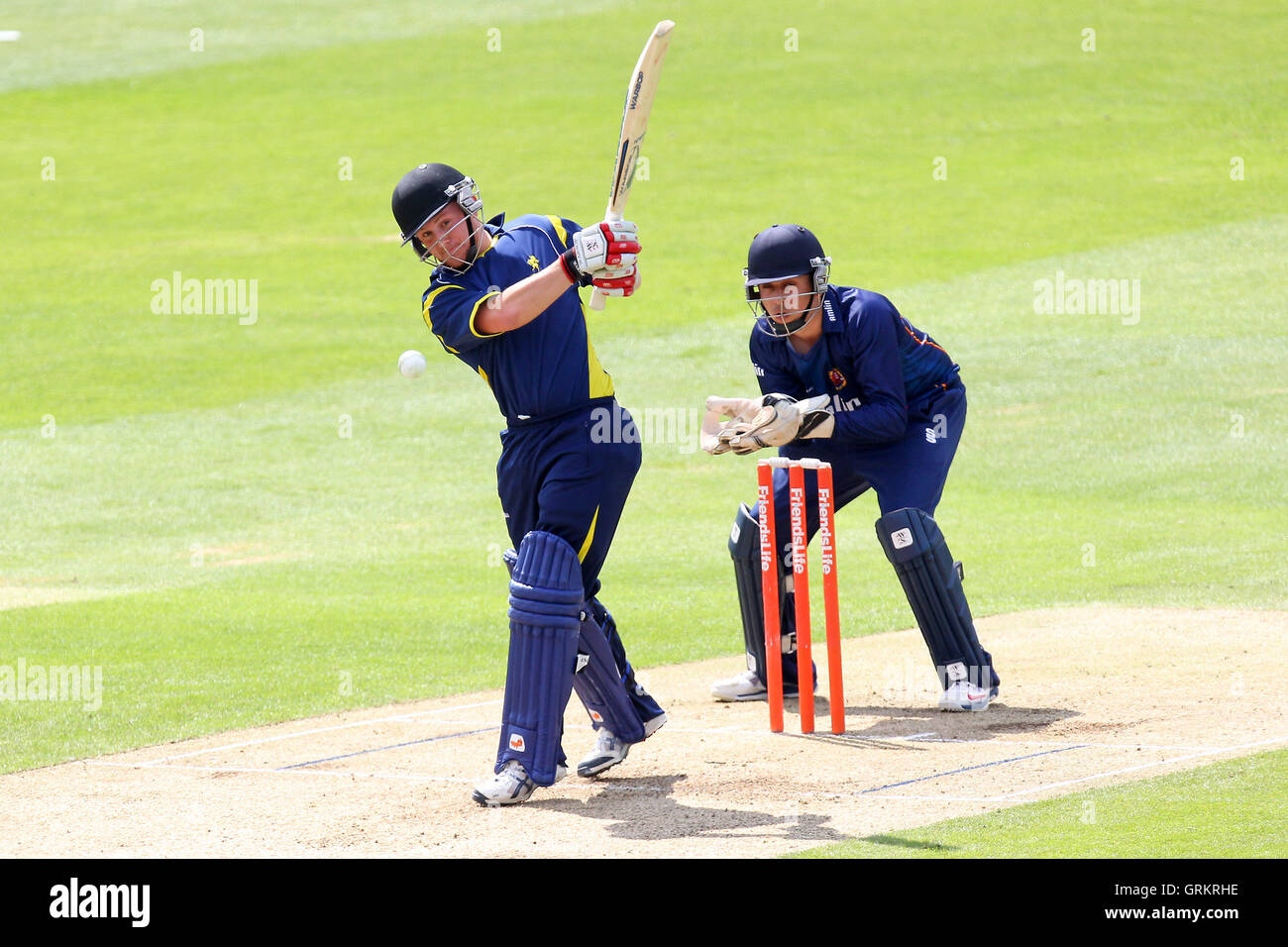 Aaron West in batting action for Unicorns as Saf Imtiaz looks on ...
