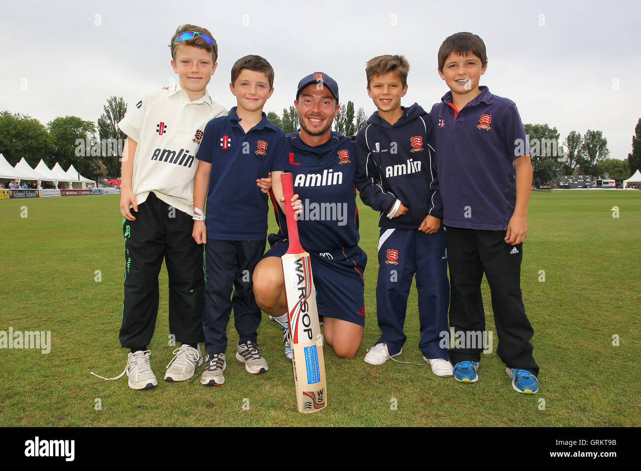 Graham Napier (C) of Essex poses for a photo with some young fans ...