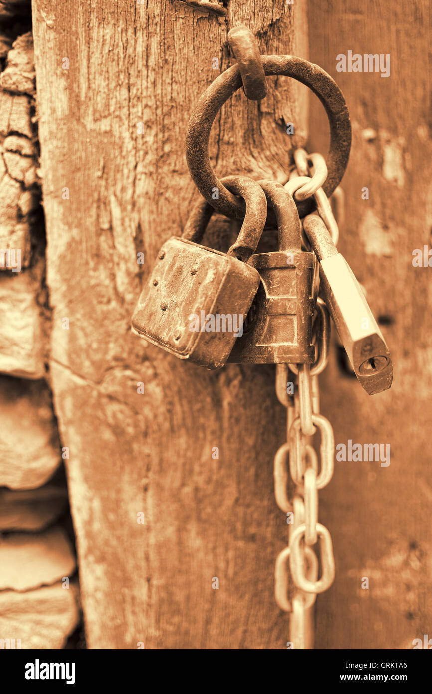 Vintage Corroded Padlocks with Chain on a Ancient Gate Background in ...