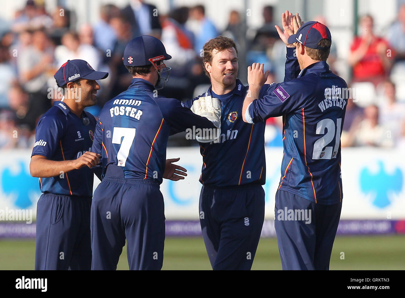 Tim Phillips of Essex (2nd R) is congratulated on the wicket of Joe ...