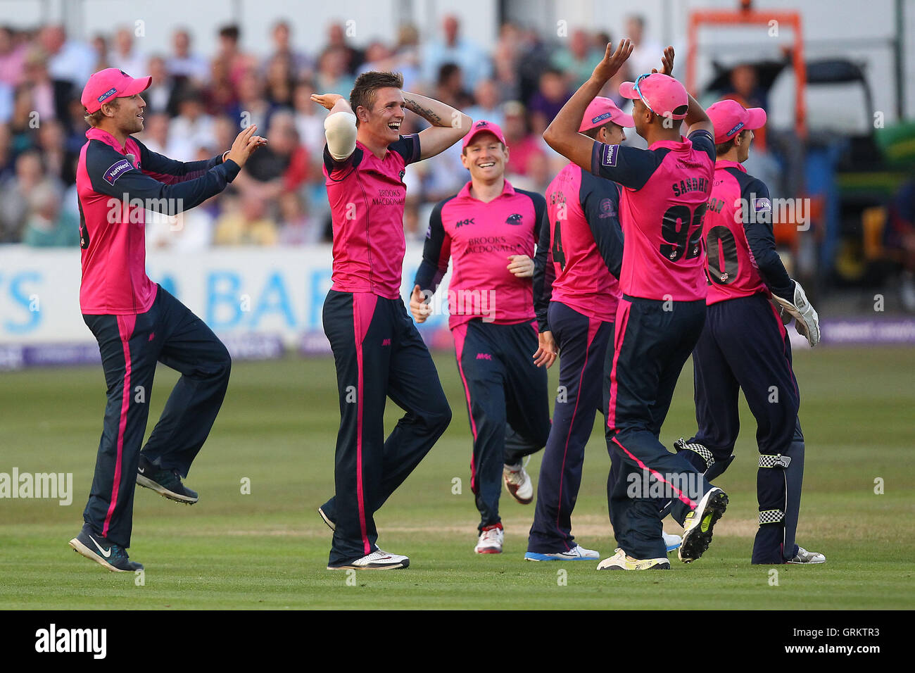 Harry Podmore of Middlesex (2nd L) celebrates the wicket of Jesse Ryder ...