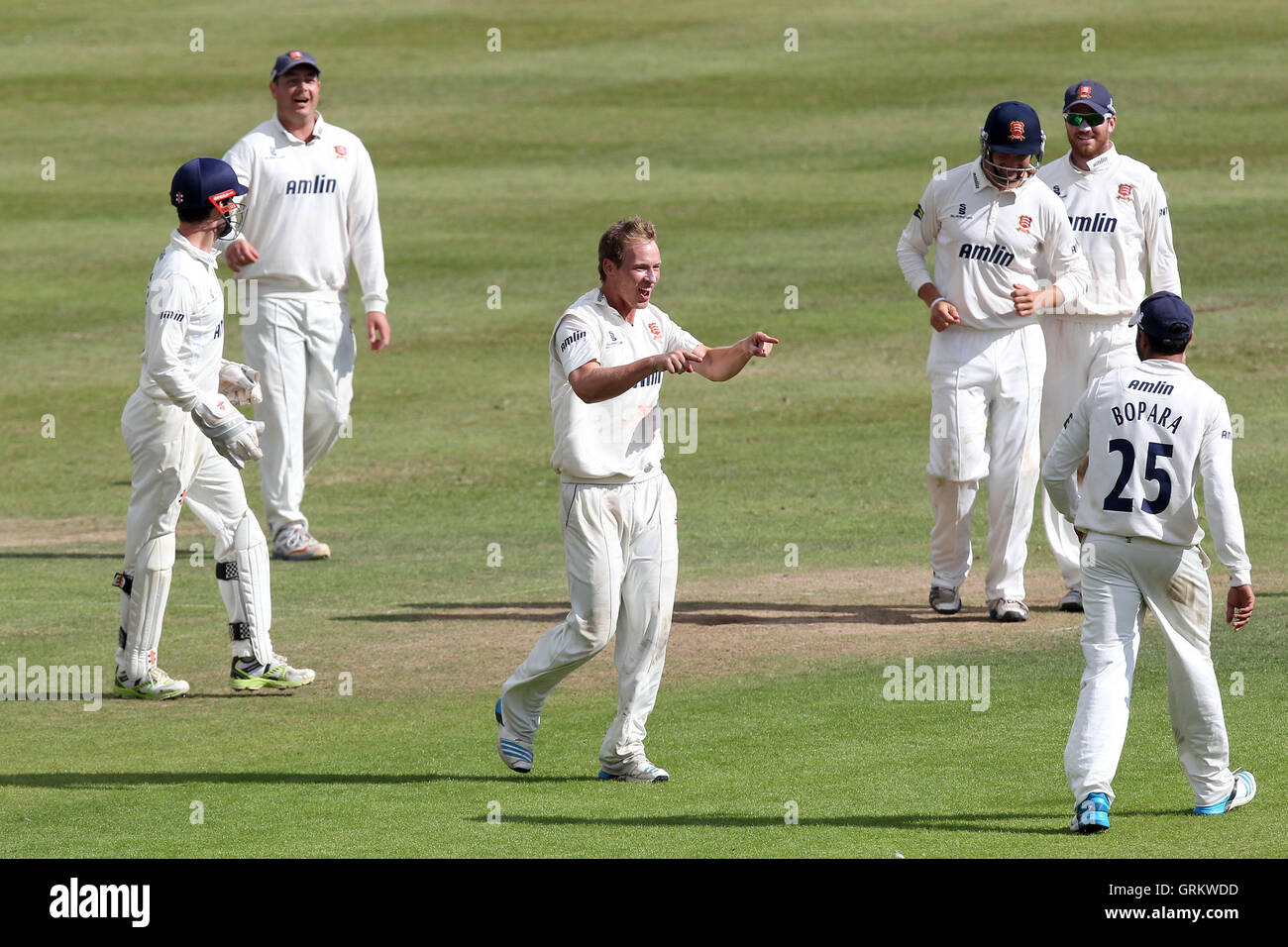 Tom Westley (C) of Essex celebrates the wicket of Jim Allenby ...