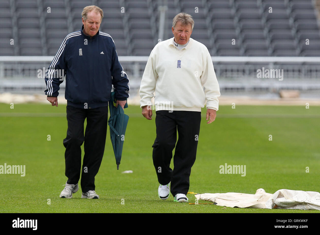 Umpires Stephen Gale (L) and Nigel Cowley consider the prospects of ...