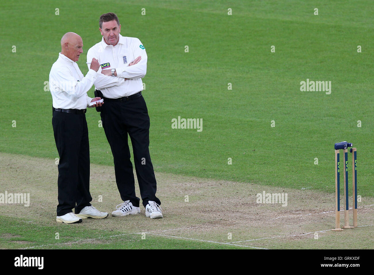 Umpires Jeffrey Evans (L) and Rob Bailey take a light meter reading as ...