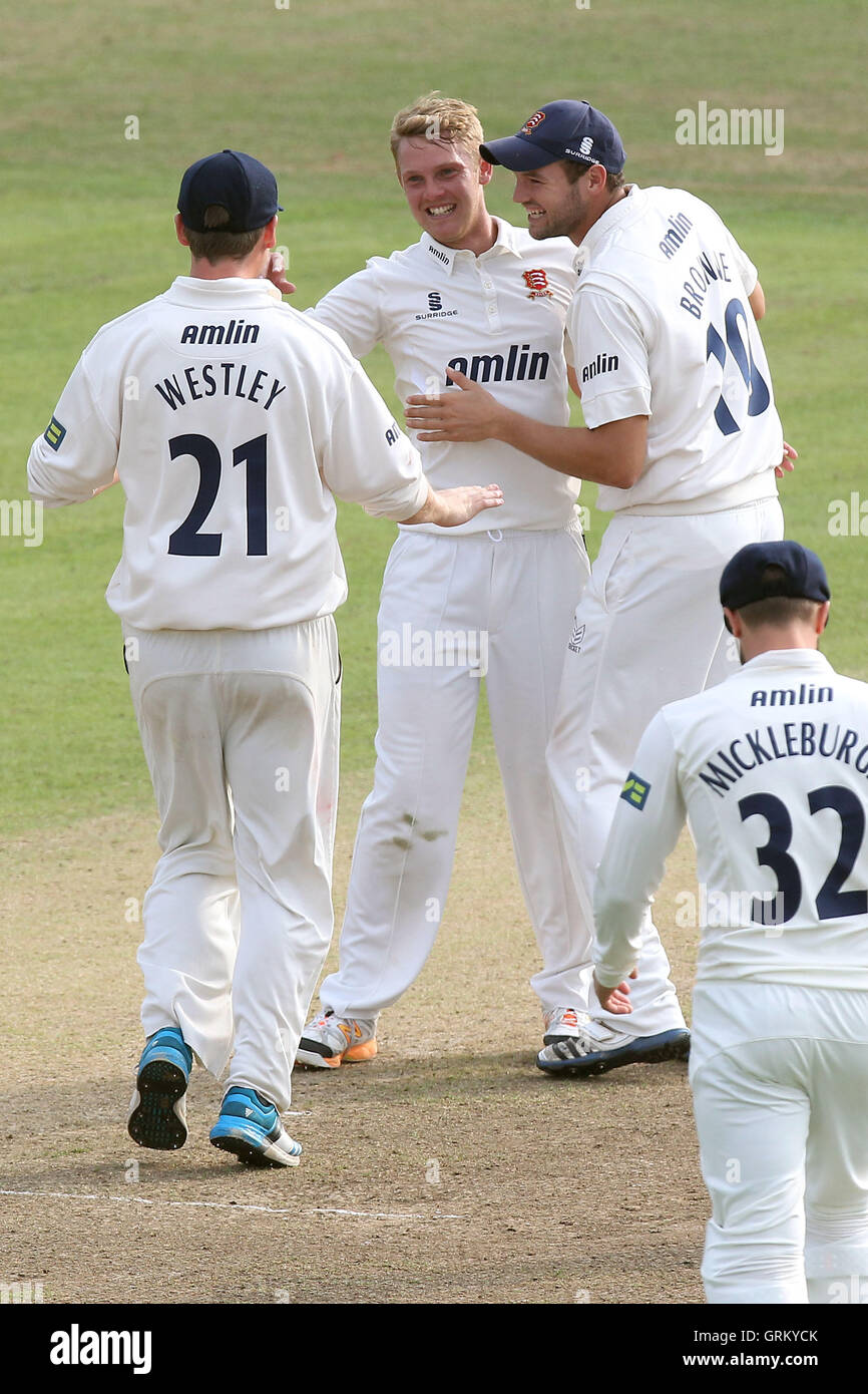 Jamie Porter of Essex (C) celebrates taking the wicket of Angus Robson ...