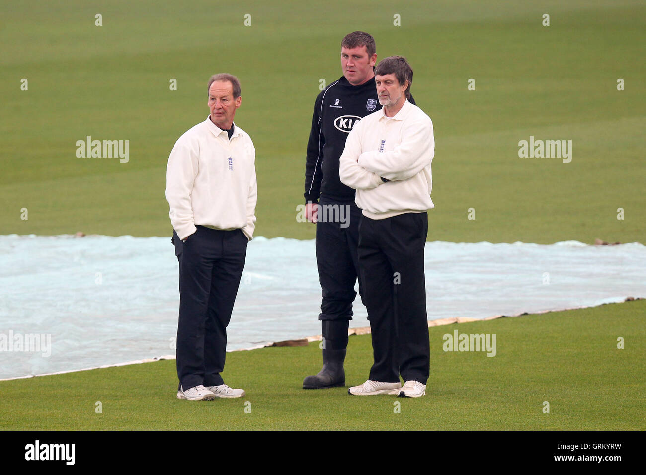 Umpires Jeremy Lloyds (L) and Peter Willey contemplate the prospects of ...