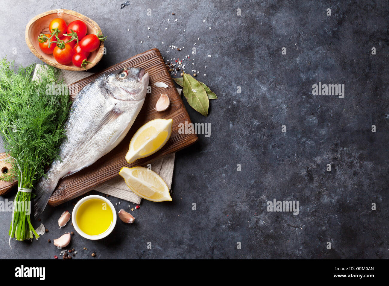 Raw fish cooking and ingredients. Dorado, lemon, herbs and spices. Top ...