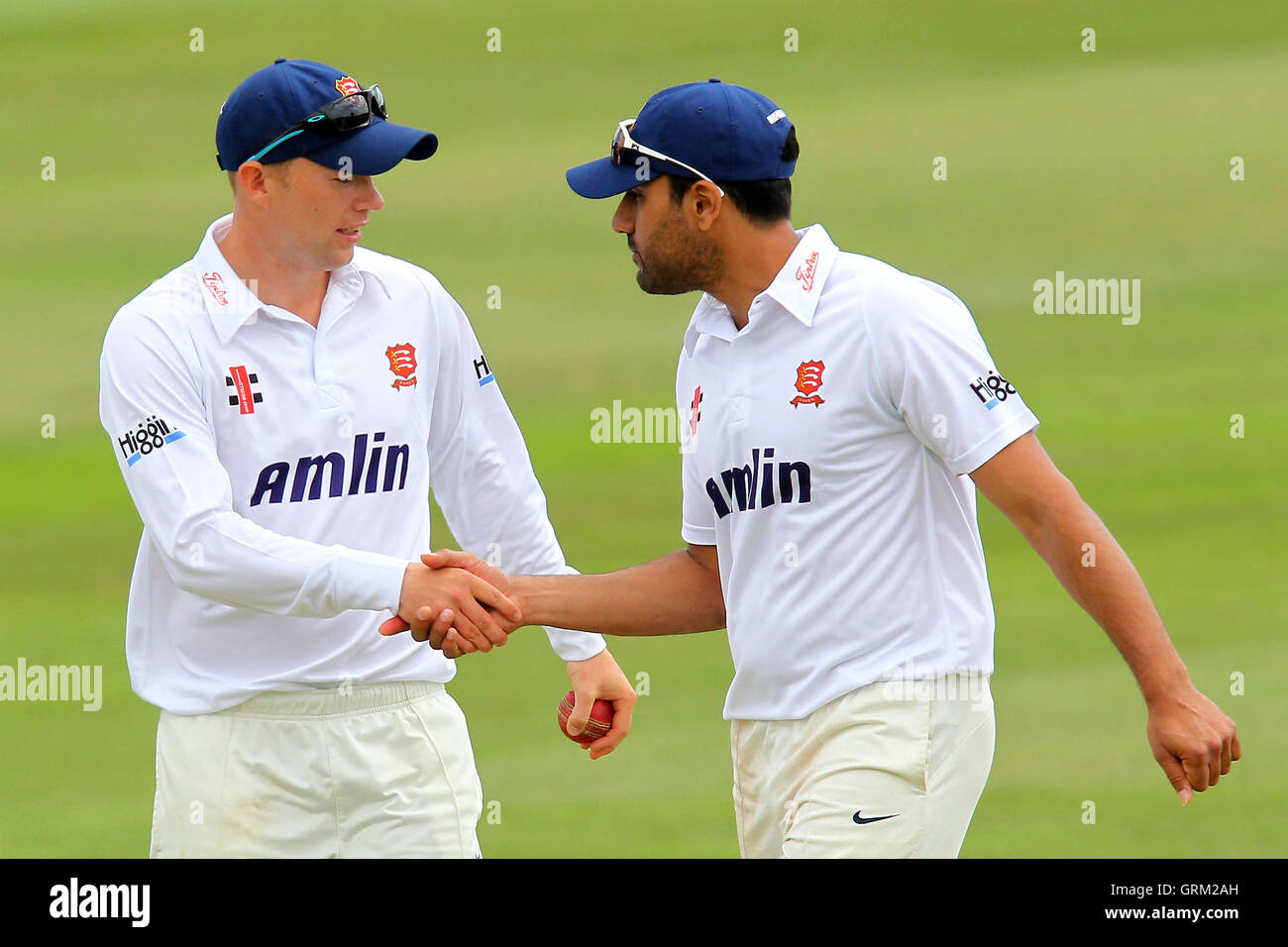 Tom Craddock (L) is congratulated on his five wicket hail by Ravi ...