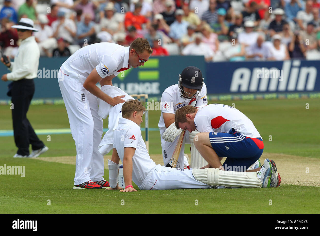 Joe Root of England receives treatment for an injury after being hit by ...