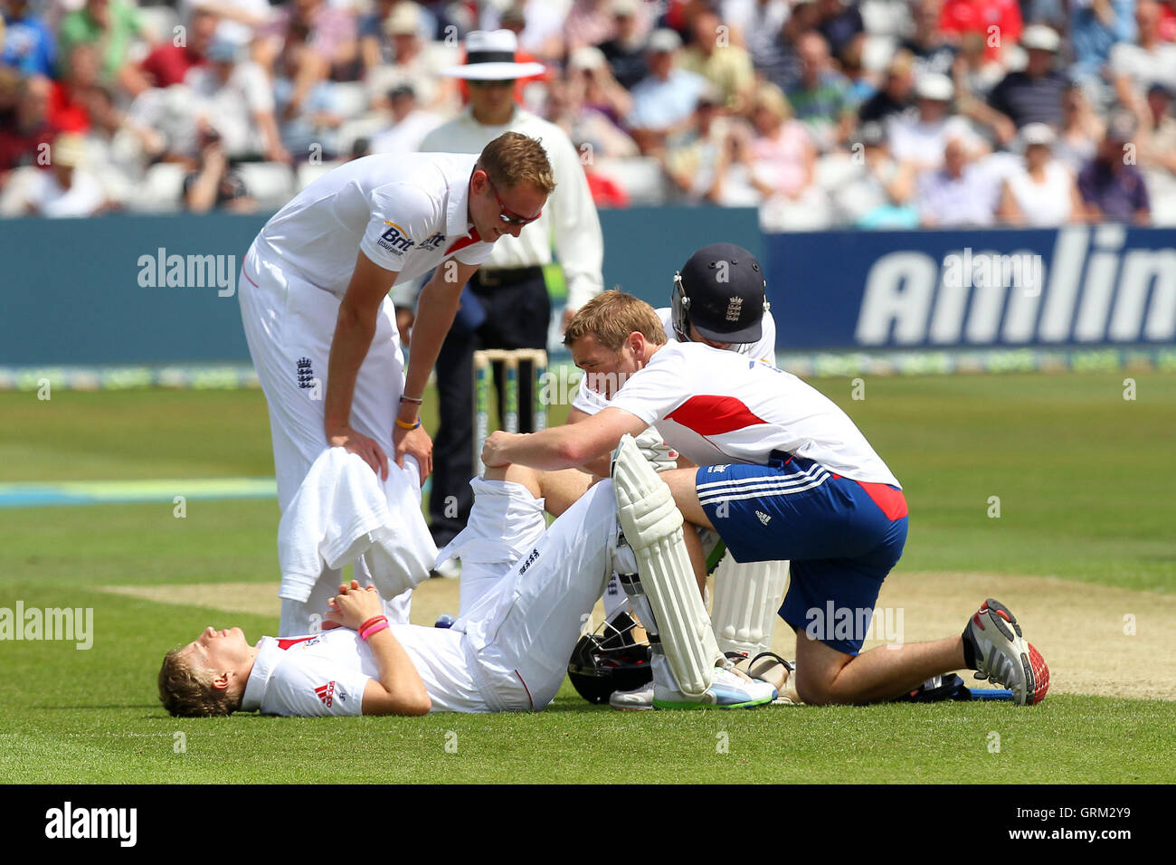 Joe Root of England receives treatment for an injury after being hit by ...