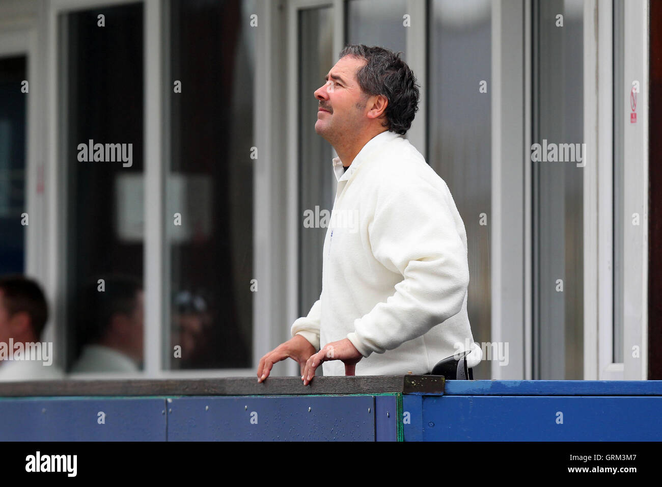 Umpire Richard Illingworth looks to the heavens as rain delays the ...