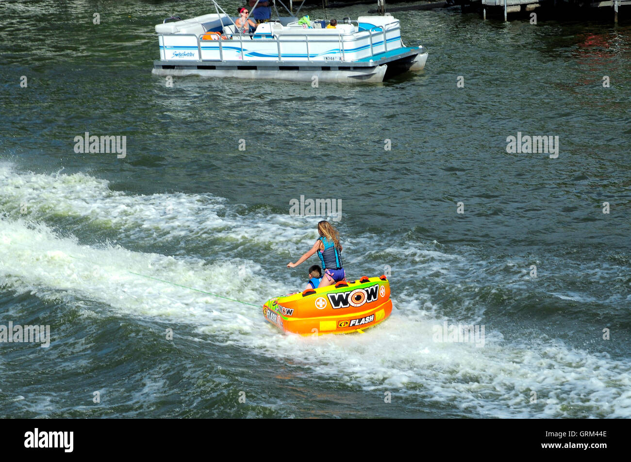 Recreational boating. Kids tubing. Girl standing Stock Photo - Alamy