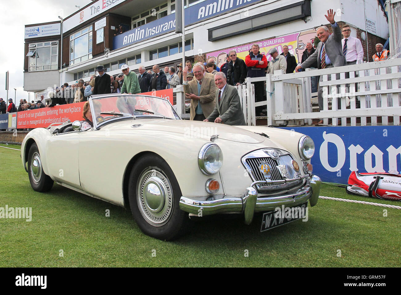 A parade of classic cars passes in front of the pavilion during the tea ...
