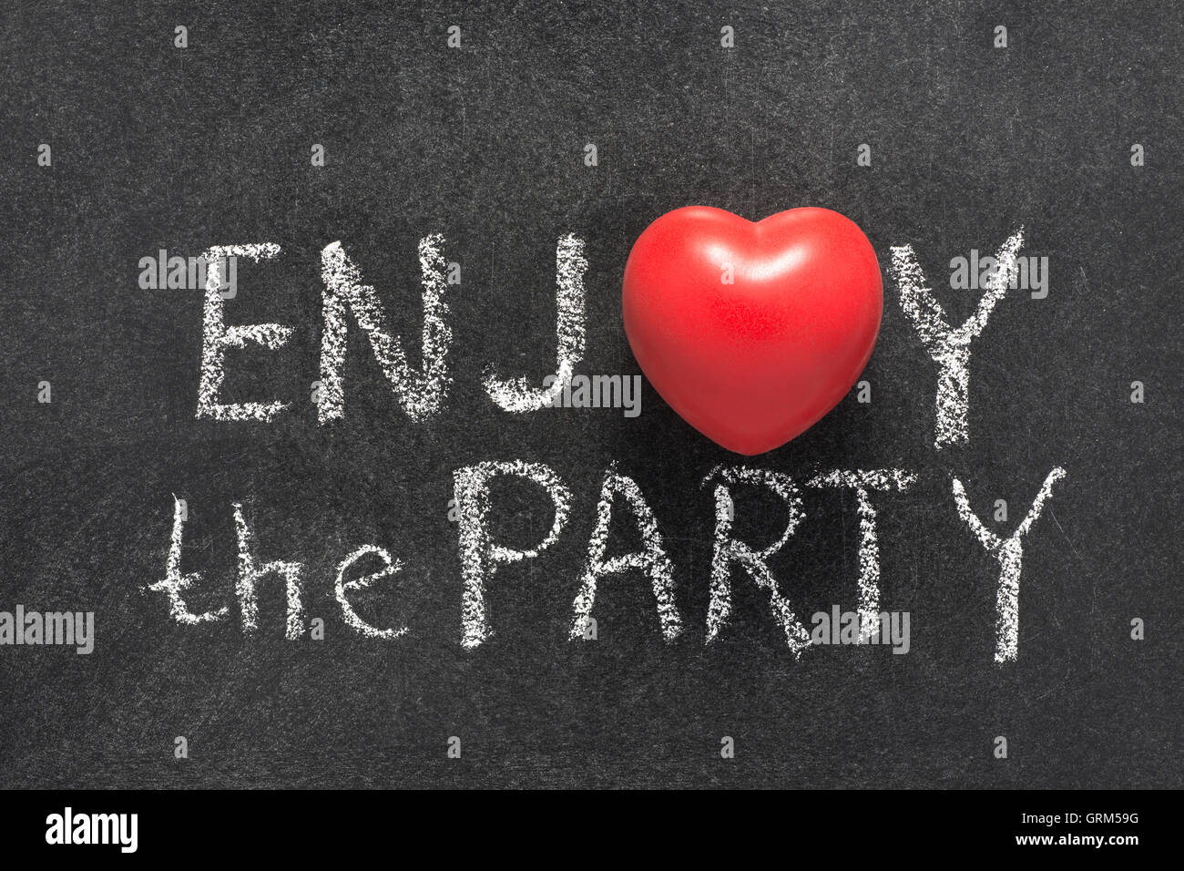 enjoy the party phrase handwritten on chalkboard with heart symbol ...