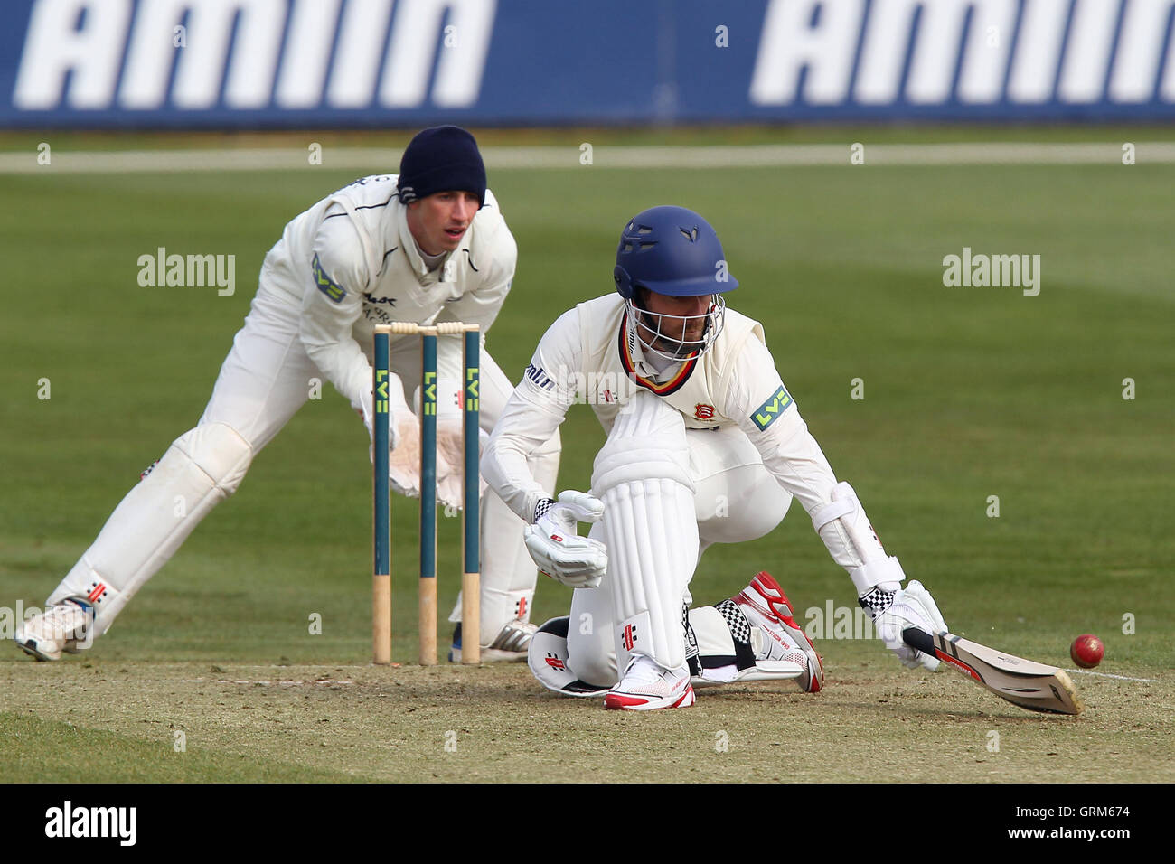 James Foster of Essex plays a one-handed shot while John Simpson looks ...