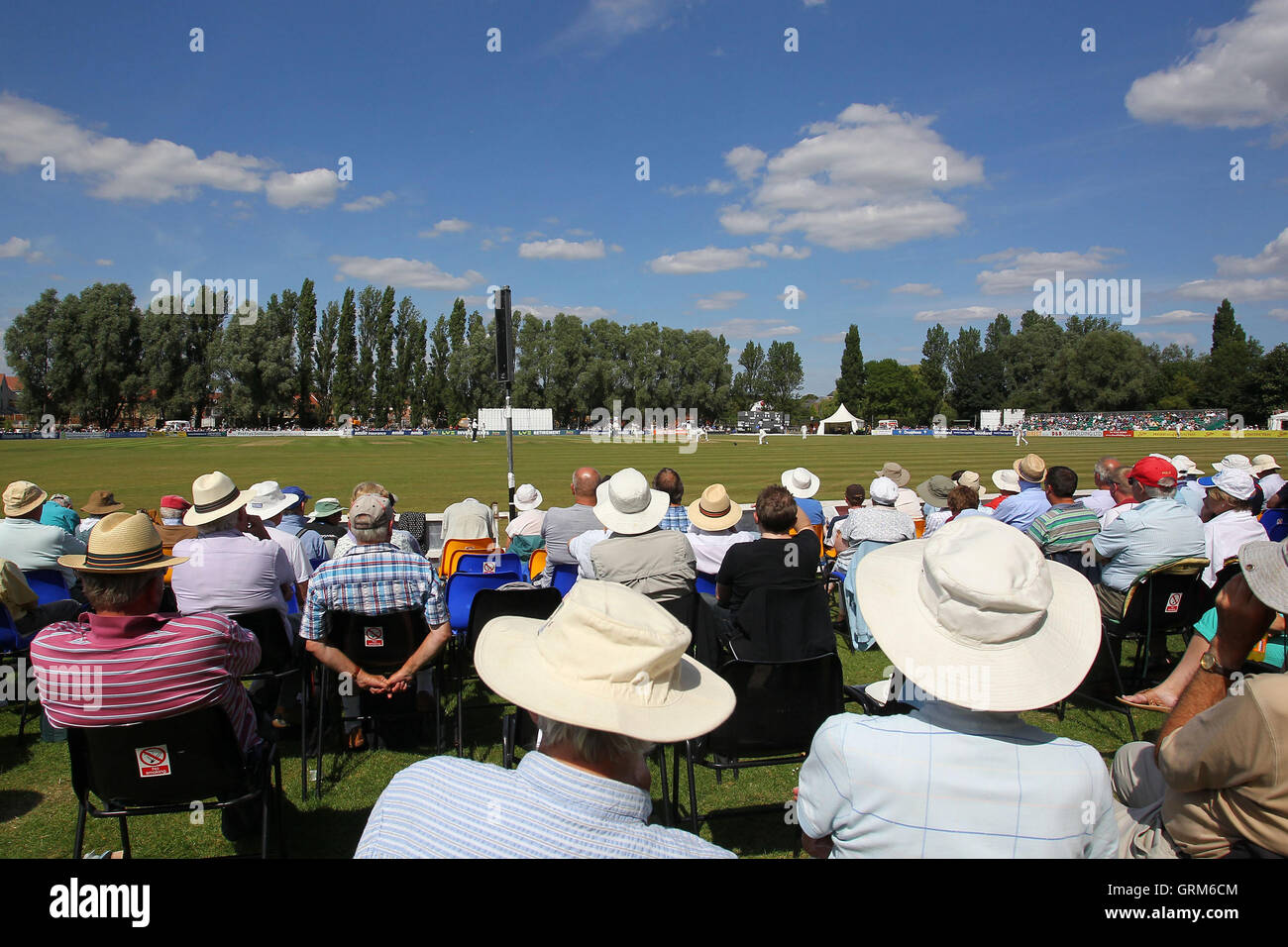 Spectators look on as play progresses on a hot day at Castle Park ...