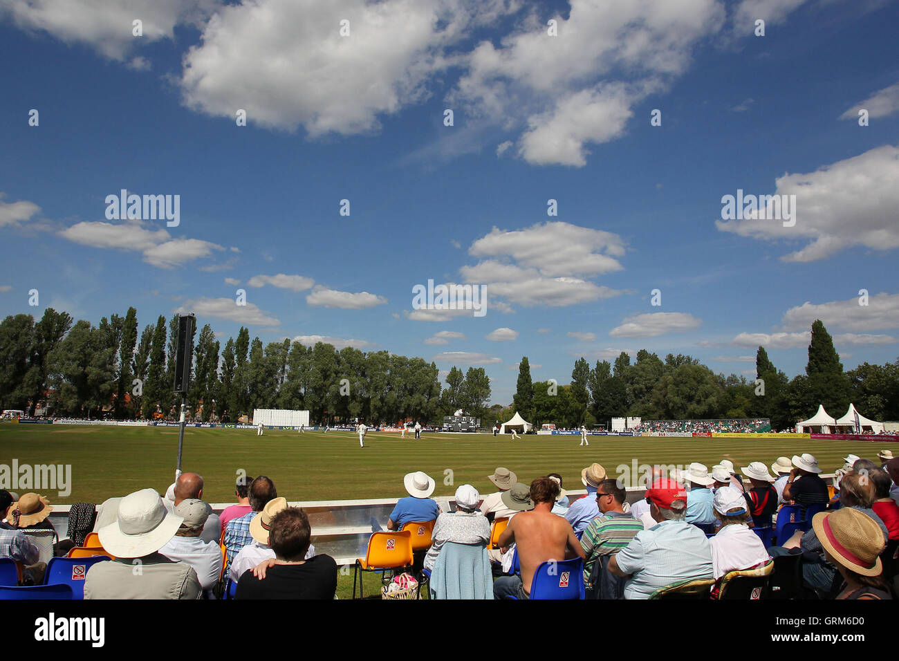 Spectators look on as play progresses on a hot day at Castle Park ...
