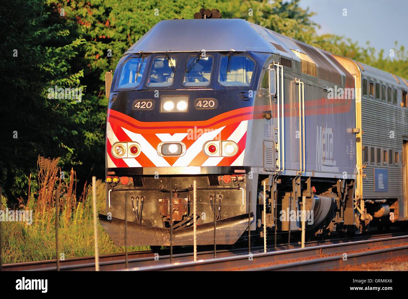 A Metra commuter train thundering through Bartlett, Illinois on a line ...