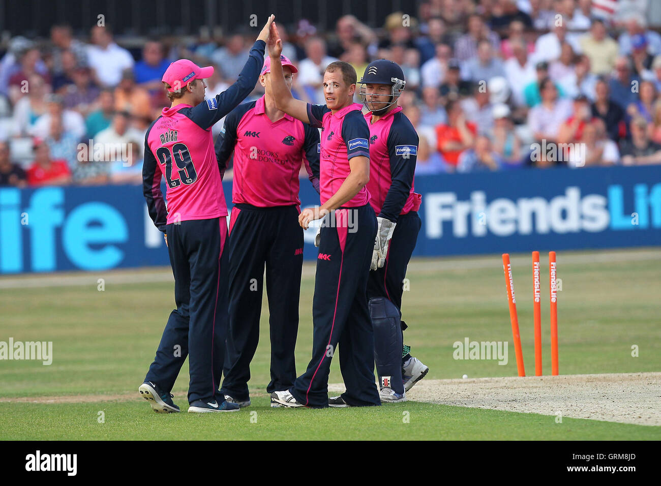 Neil Dexter of Middlesex (2nd R) celebrates the wicket of James Foster ...