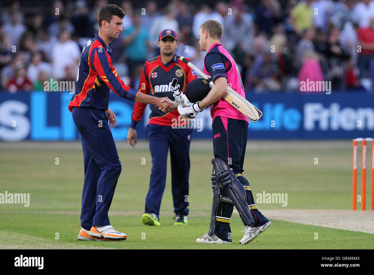 Reece Topley of Essex (L) shakes hands with Middlesex batsman Adam ...