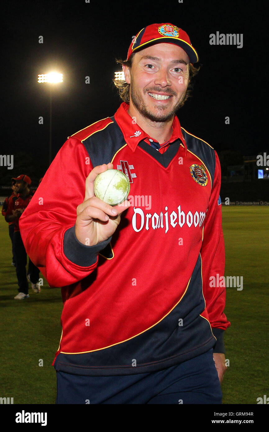 Graham Napier of Essex holds up the ball after taking seven wickets ...