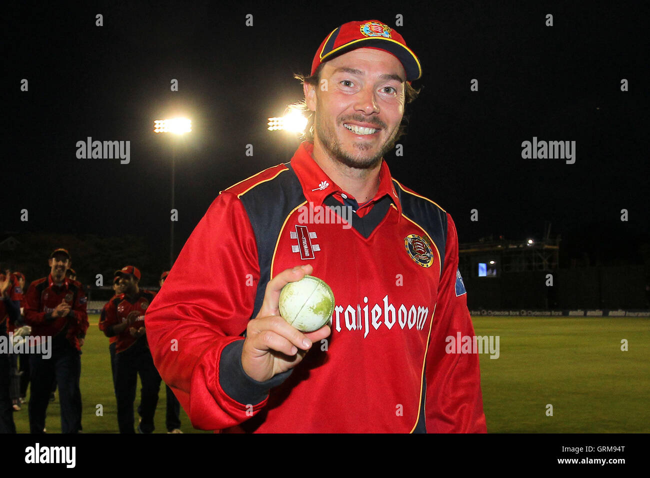 Graham Napier of Essex holds up the ball after taking seven wickets ...