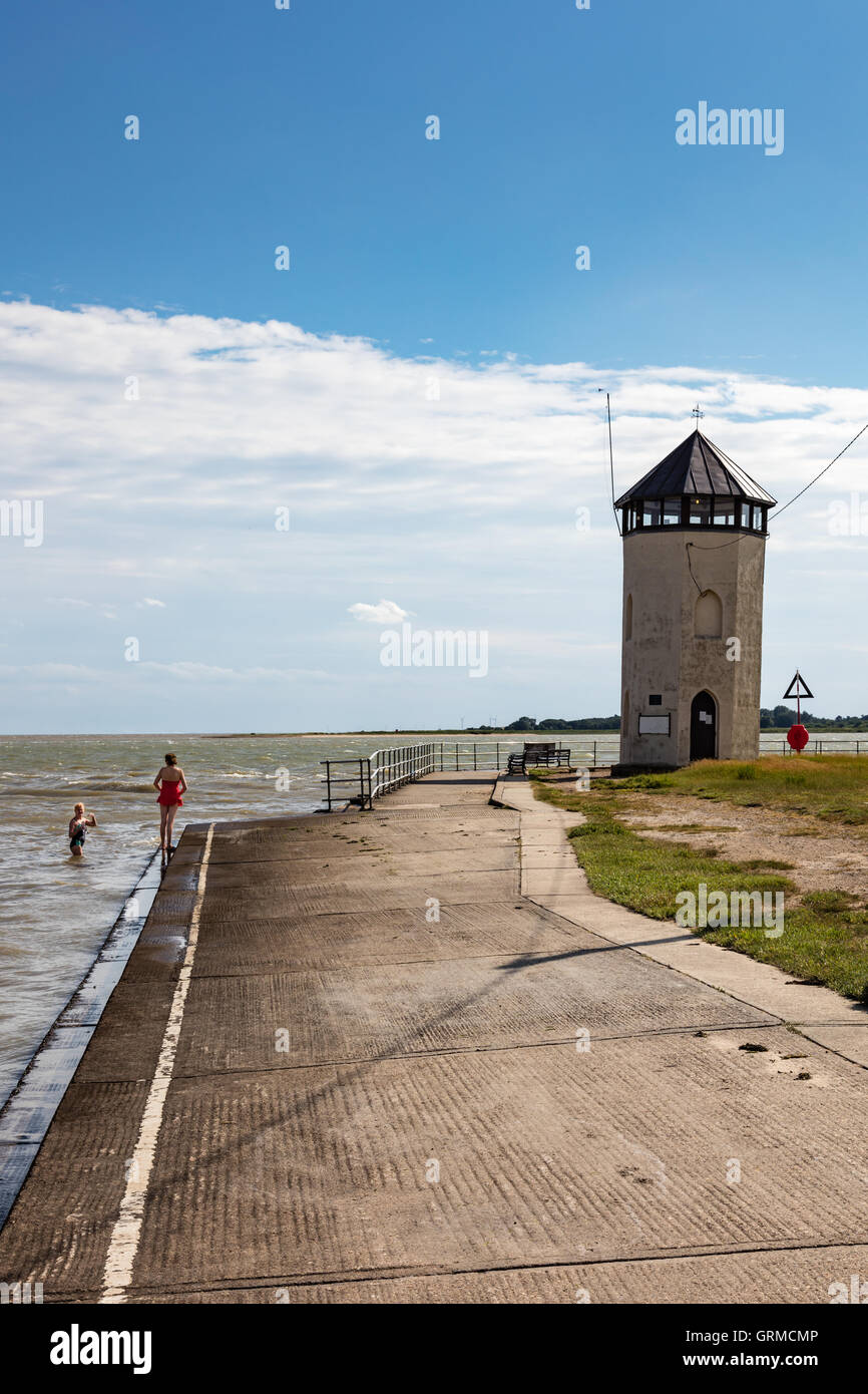 Two women swim near Bateman's Tower, on the Western promenade and beach ...