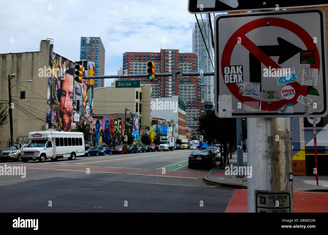 Graffiti and murals on traffic signs and building facade along ...