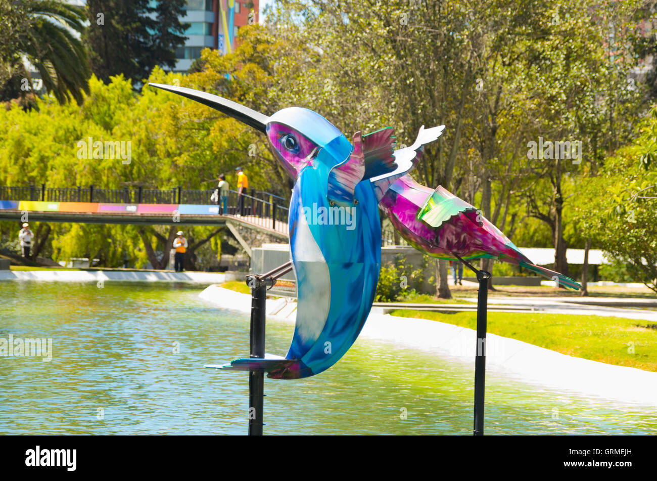 Colorful mockingbird art installation placed on poles inside water ...