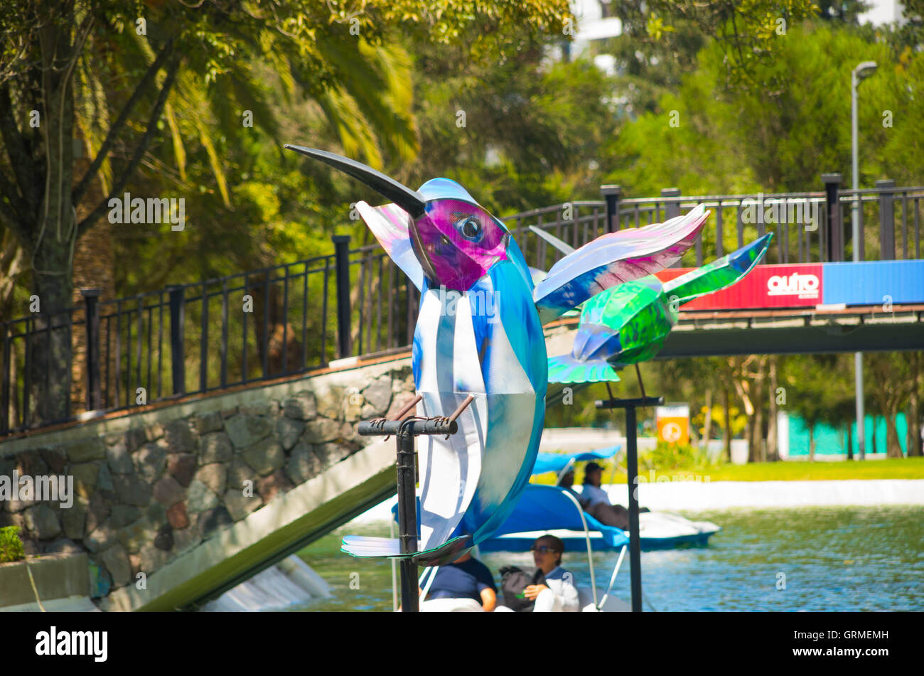 Colorful mockingbird art installation placed on poles inside water ...