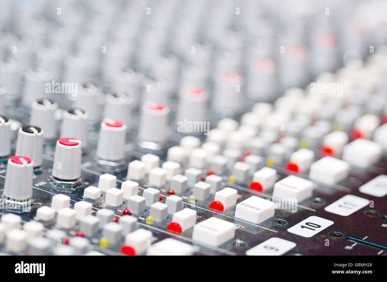 Closeup mixing faders and knobs as seen from above side angle, artistic ...