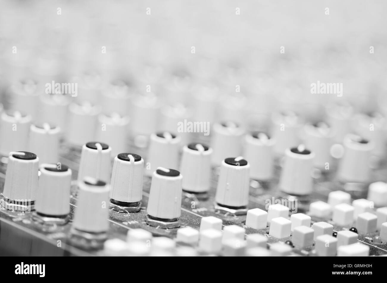 Closeup mixing console knobs as seen from above side angle, artistic ...