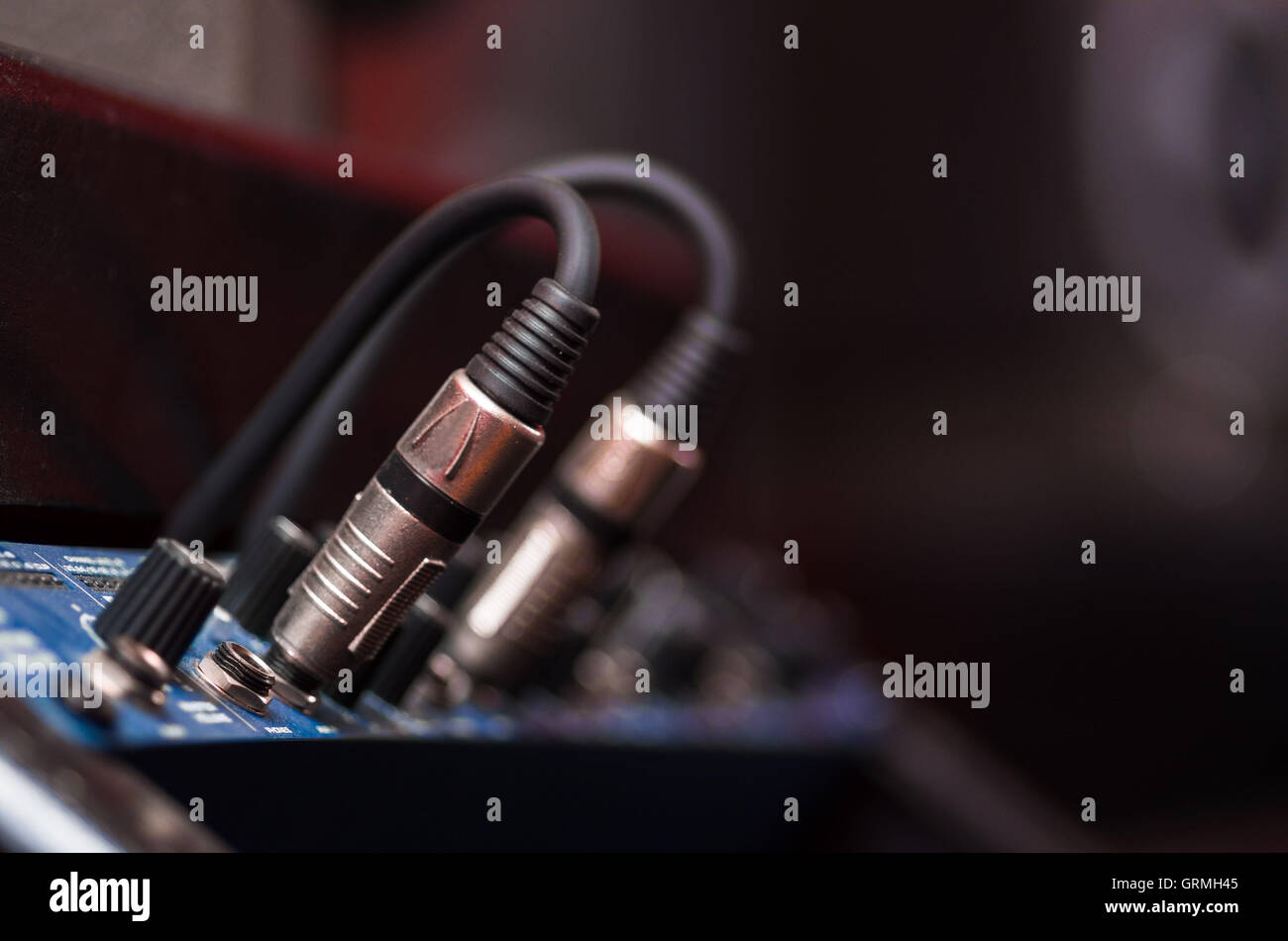 Closeup audio cables plugged into studio hardware, artistic equipment ...