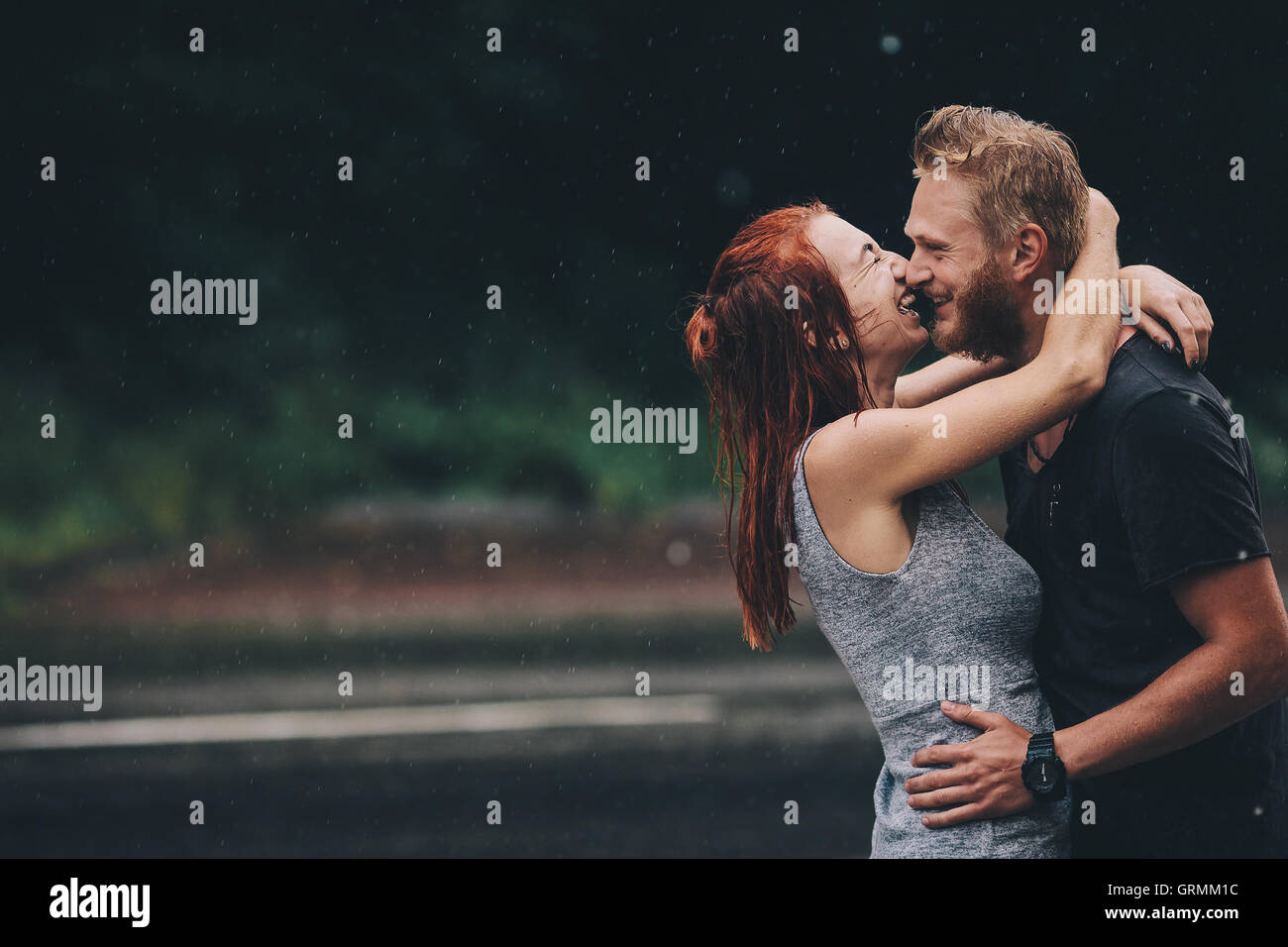 beautiful couple hugging in the rain Stock Photo - Alamy
