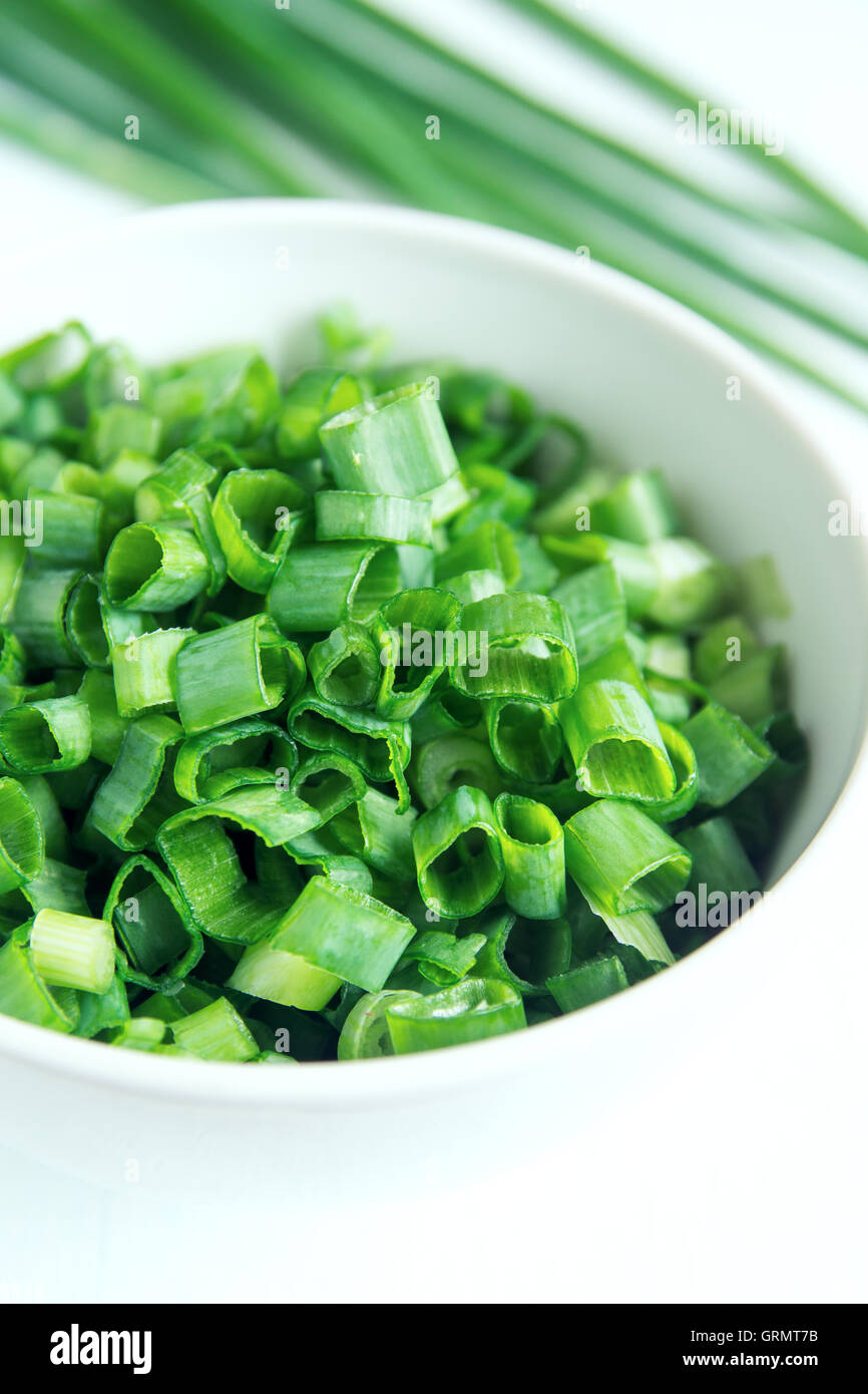 Chopped chives in white bowl, organic green ingredient for cooking ...