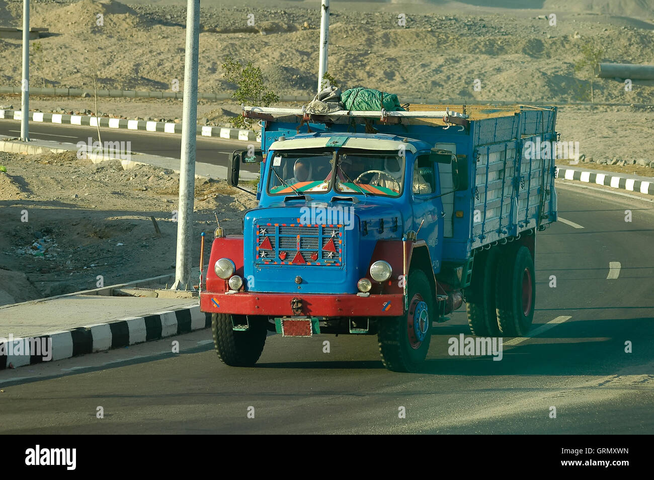 Old truck with arabian people on road of Egypt Stock Photo - Alamy