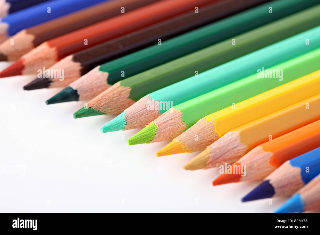 Colored pencil in row on white background Stock Photo - Alamy