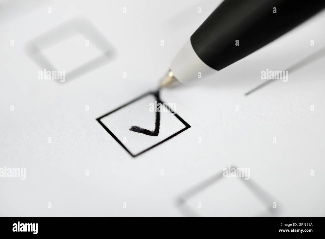 Ticking checking marking a cross in the box Stock Photo - Alamy