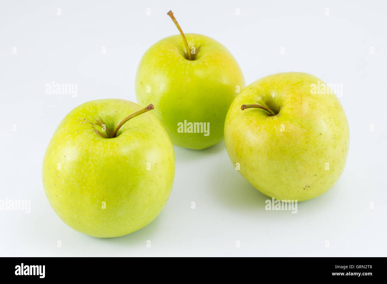 Three fresh green apples on white background Stock Photo - Alamy