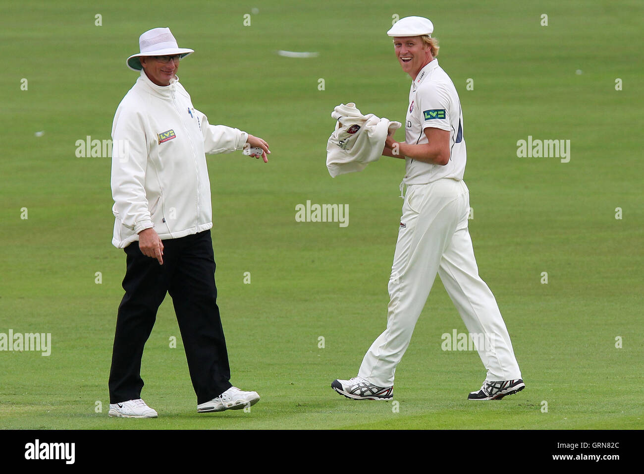 Kent bowler Mark Davies (R) shares a joke with umpire Neil Mallender by ...