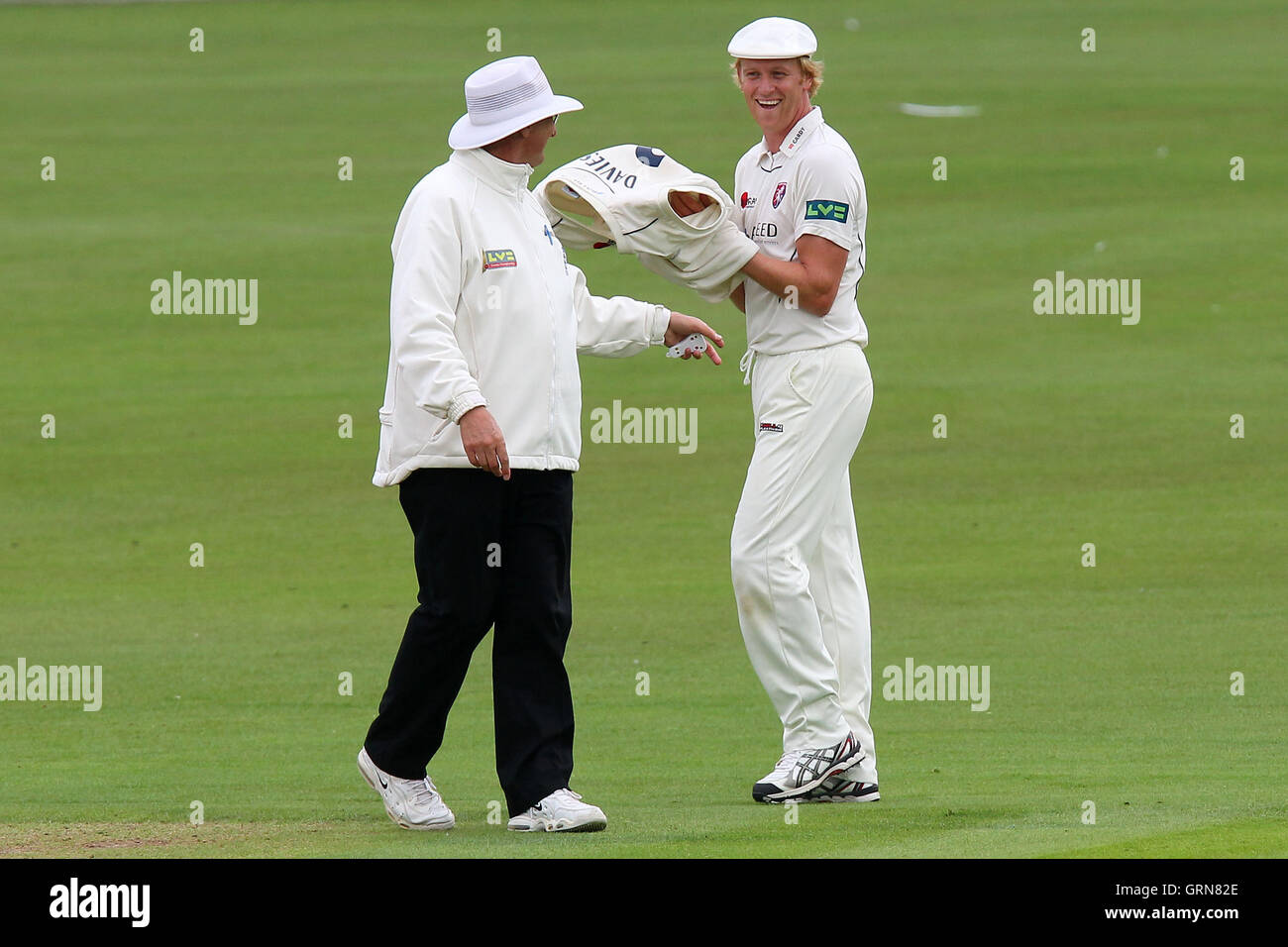 Kent bowler Mark Davies (R) shares a joke with umpire Neil Mallender by ...