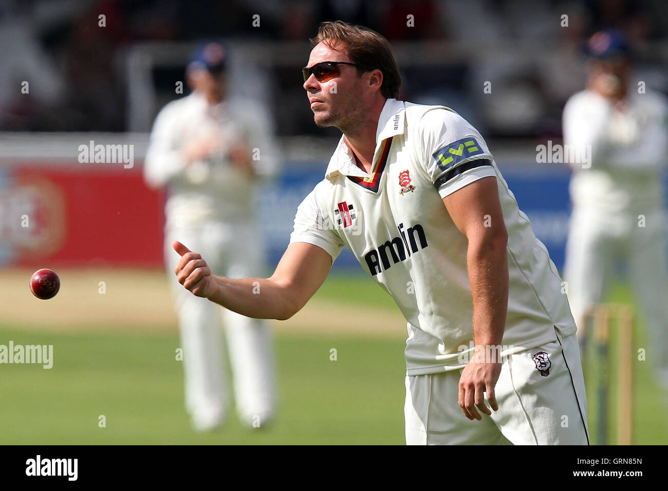 Graham Napier of Essex throws the ball and is wearing a black armband ...