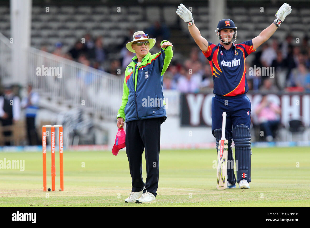 Umpire Jeffrey Evans (C) and Essex batsman Hamish Rutherford signal to ...