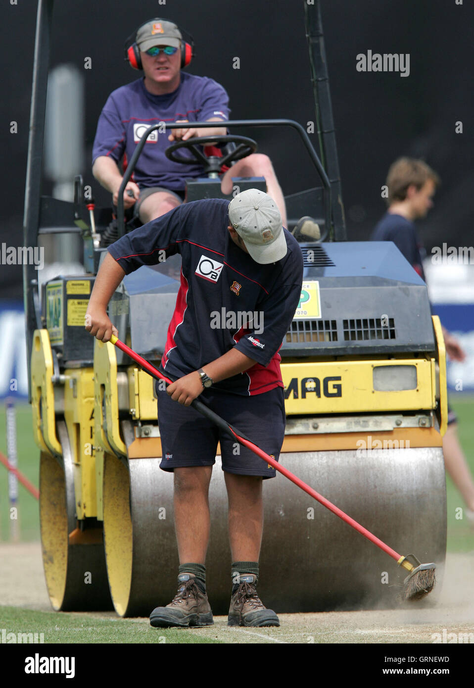 Ground staff work on the pitch between innings - Ford County Ground ...