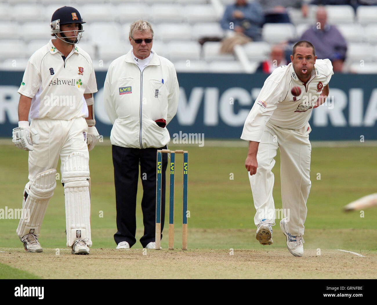 Andrew Hall in bowling action for Northants as Mark Pettini looks on ...
