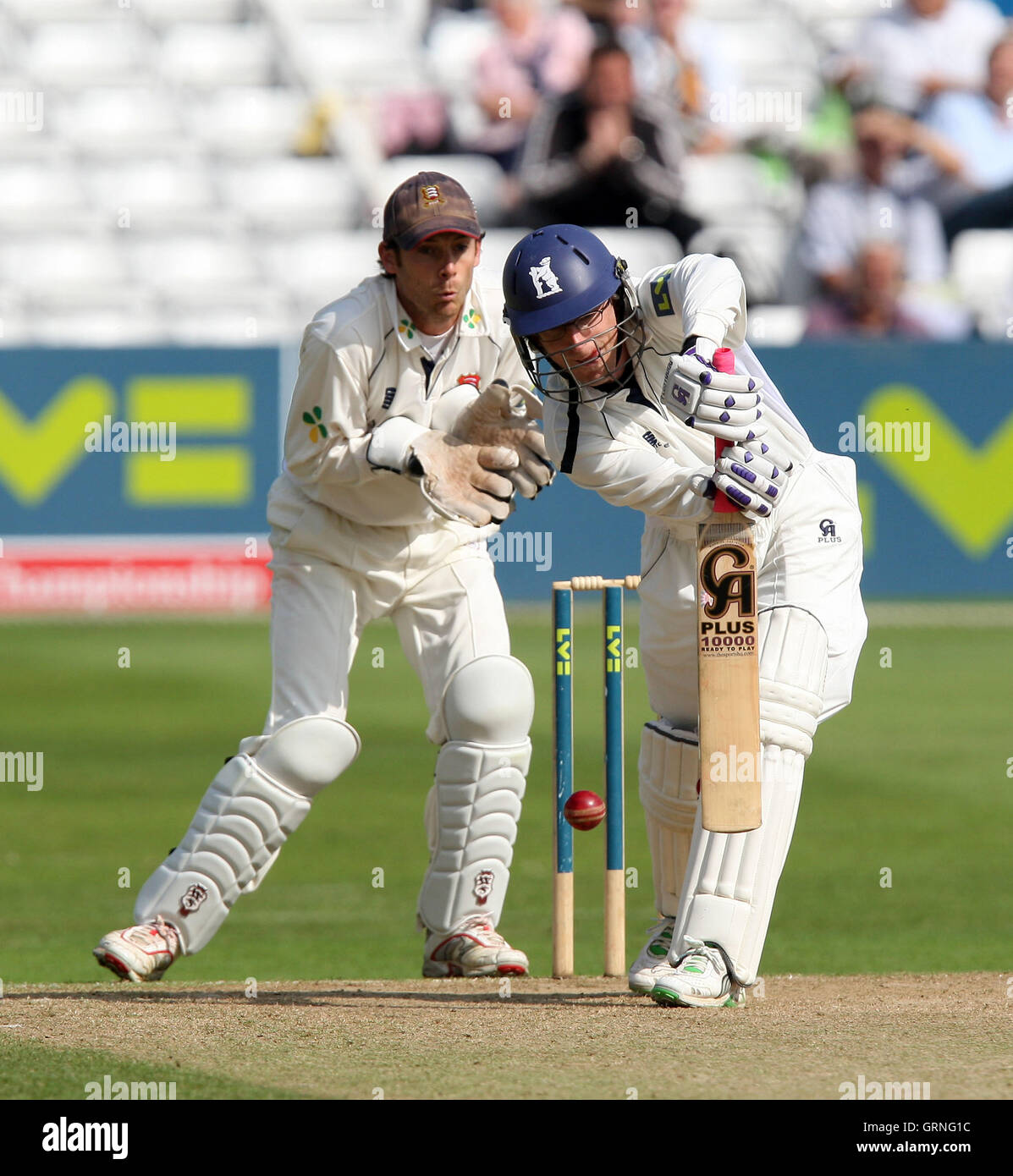 James Foster looks on behind the stumps as Warks batsman Tony Frost ...