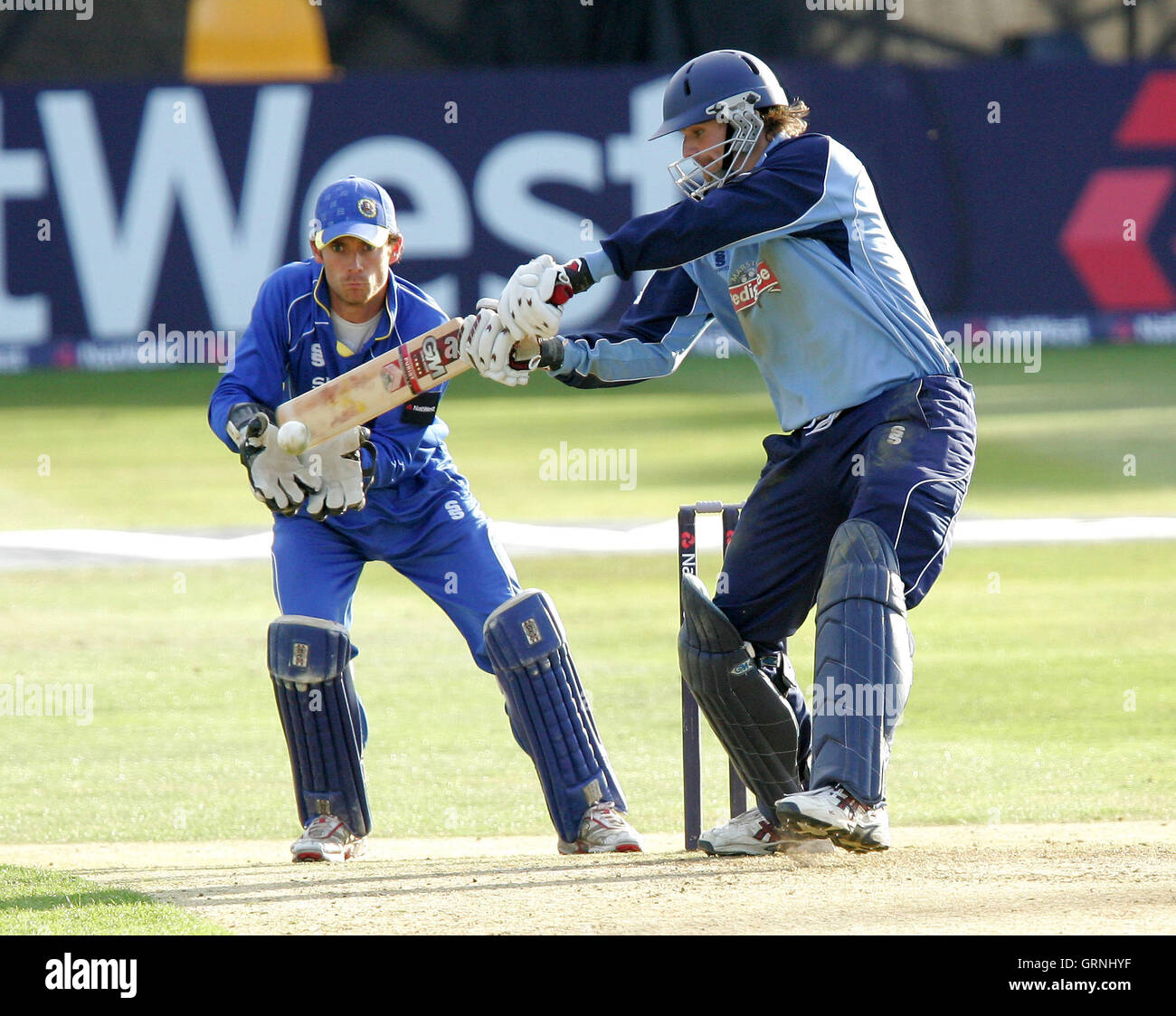 Alex Gidman of Glos hits out as James Foster looks on for Essex - Essex ...