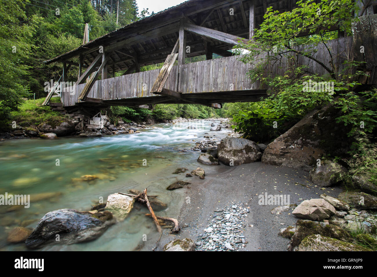 Waterfall with bridge in wild nature Stock Photo - Alamy