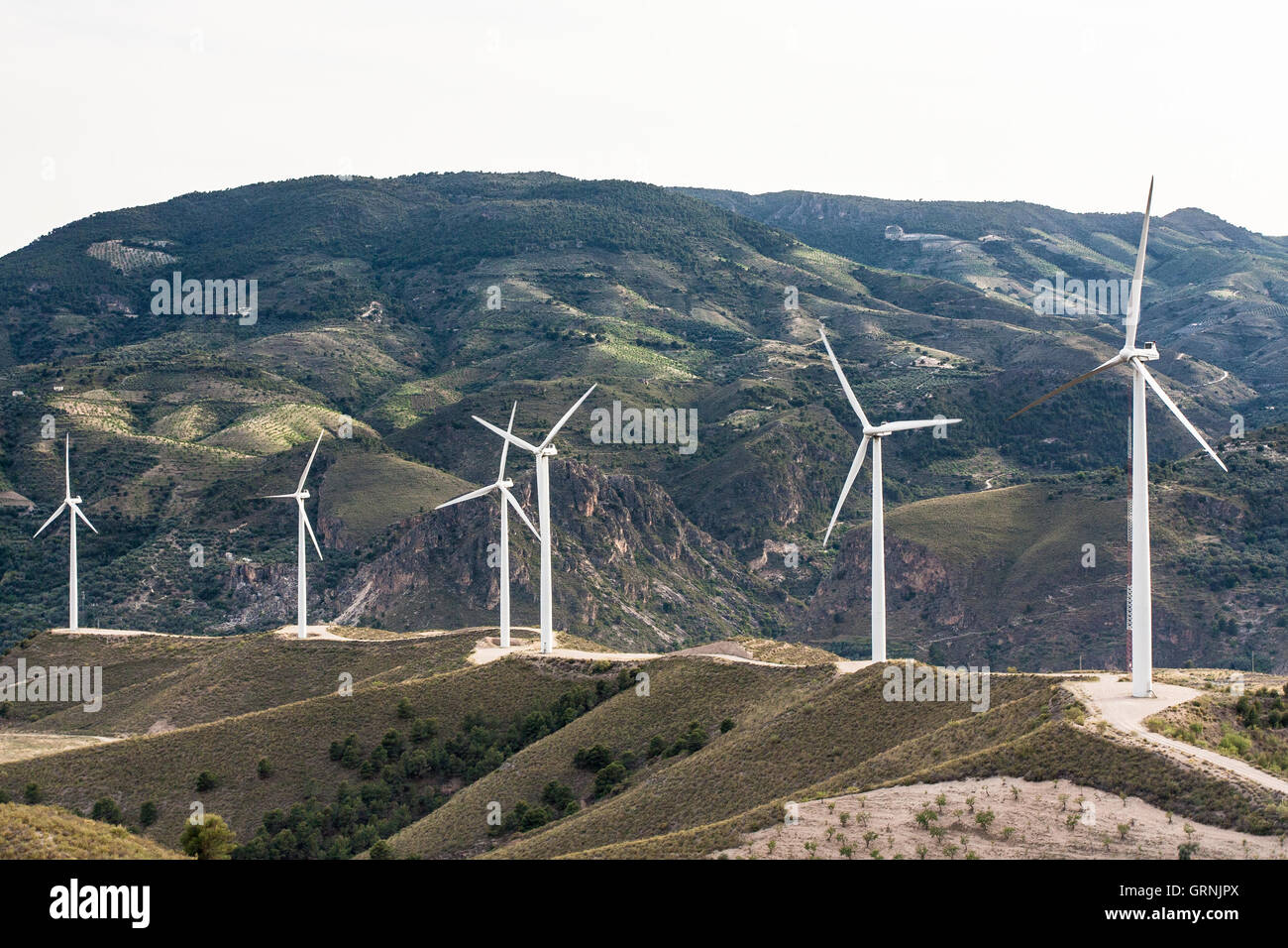 Windmill in mountains on sly background Stock Photo - Alamy